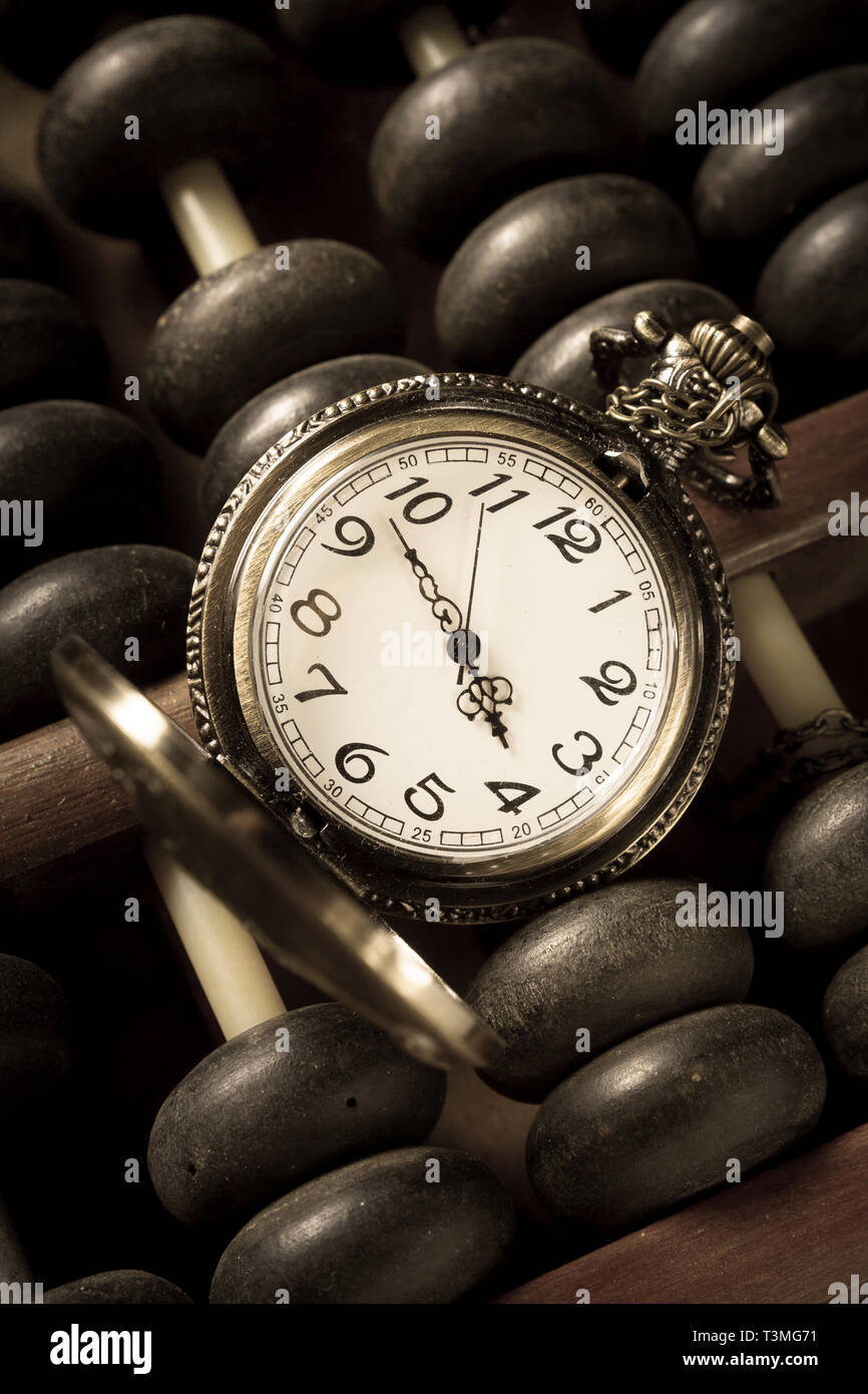 Pocket watch with old abacus,vintage color style Stock Photo - Alamy