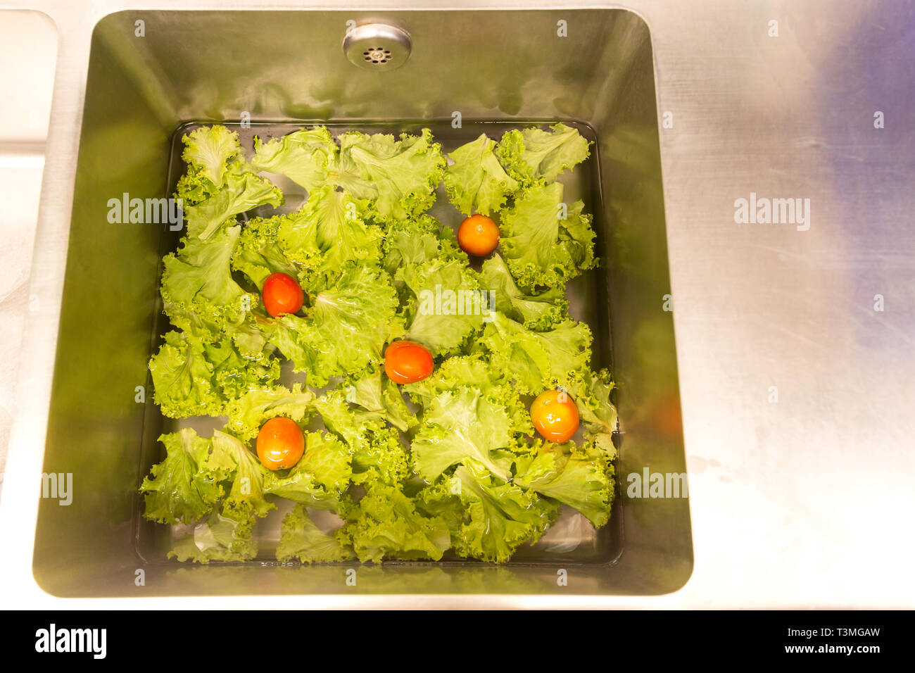 Fresh vegetables washing in kitchen sink healthy care concept Stock ...