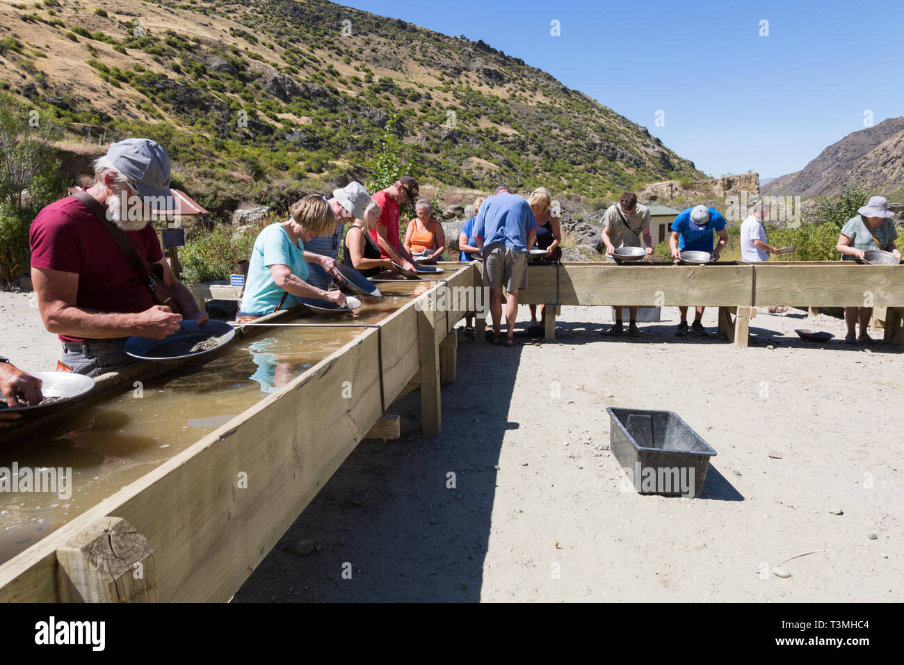 Tourists panning for gold, The Goldfields Mining Centre, New Zealand ...
