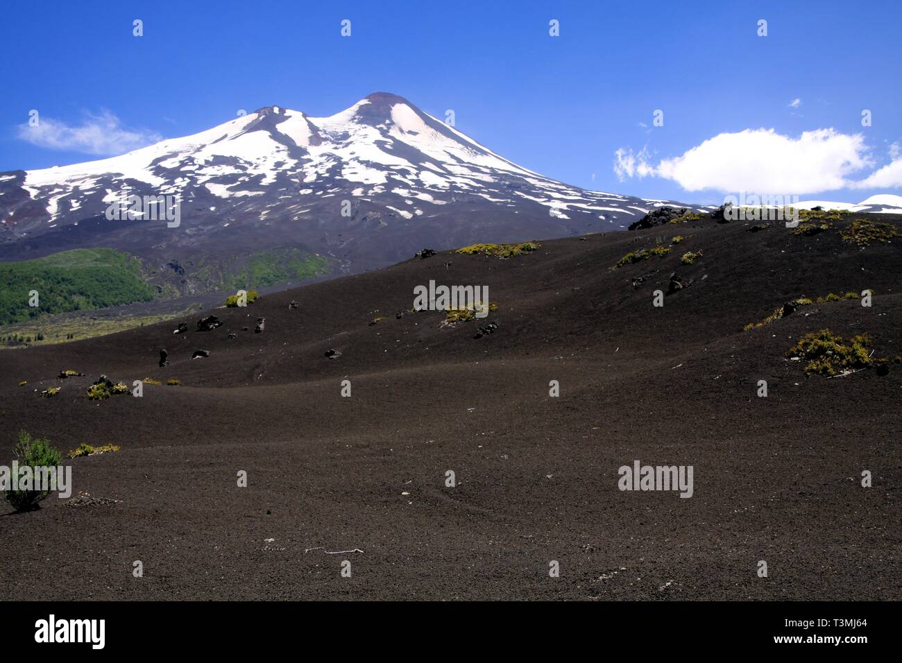 Wide field of volcanic lava ash on peak of black Volcano Llaima with ...