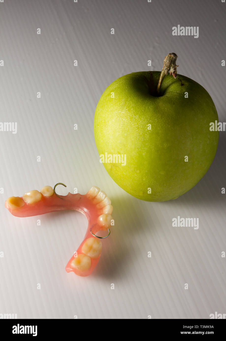 Take care teeth for good mouth health,dentures with green apple Stock ...