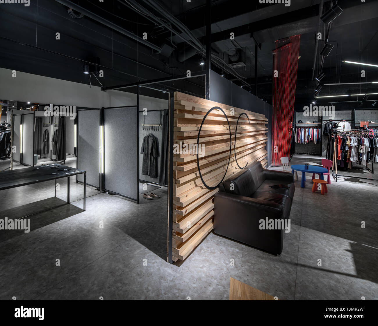 Modern clothes shop with large selection of different wear and shoes ...