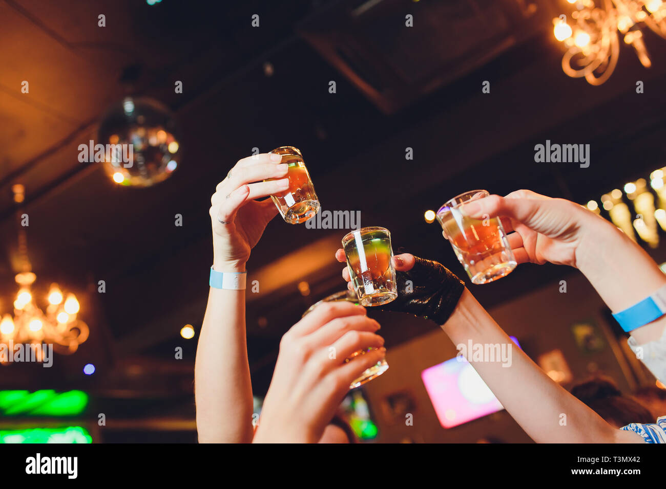 Hand holding a glass shot with vodka shot Stock Photo - Alamy
