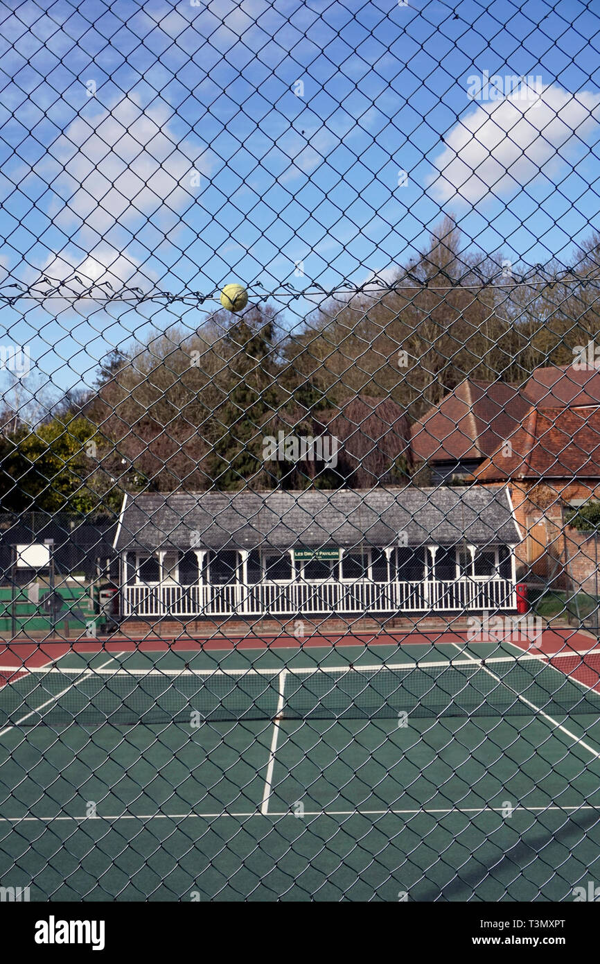 tennis court with ball stuck in surrounding fencing Castle Hedingham ...