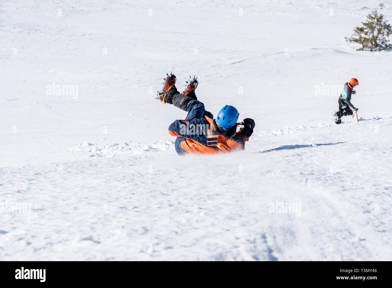 Climber practices self arrest with ice ax at mountaineering school ...