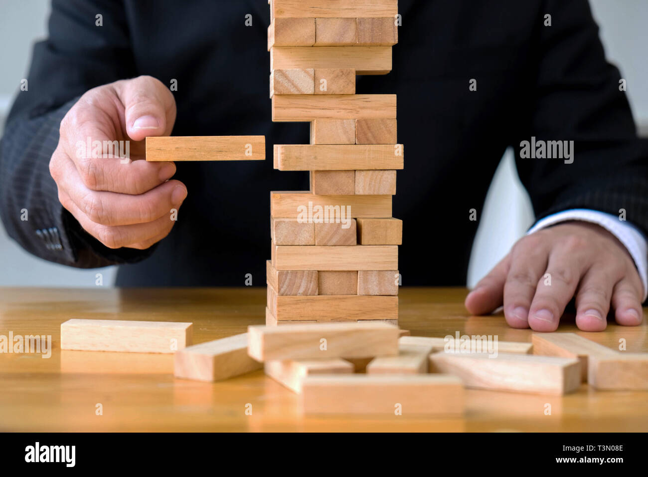 Businessmen picking domino blocks to fill the missing dominos. Growing ...