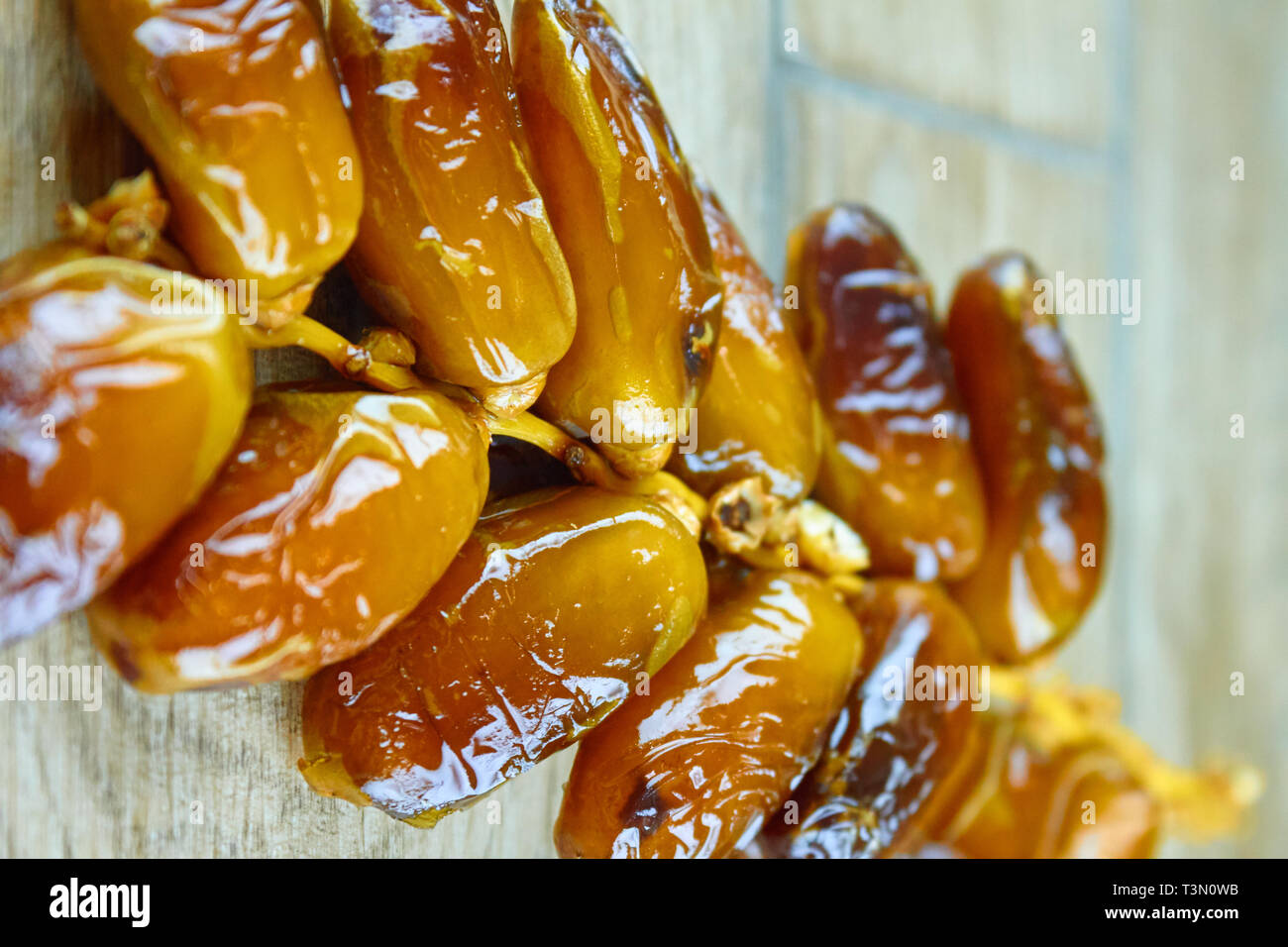 Sweet arabic algerian dates fruits on a wooden floor Stock Photo - Alamy