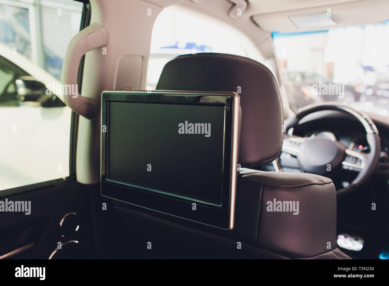 Car inside. Interior of prestige luxury modern car. Three TV displays ...