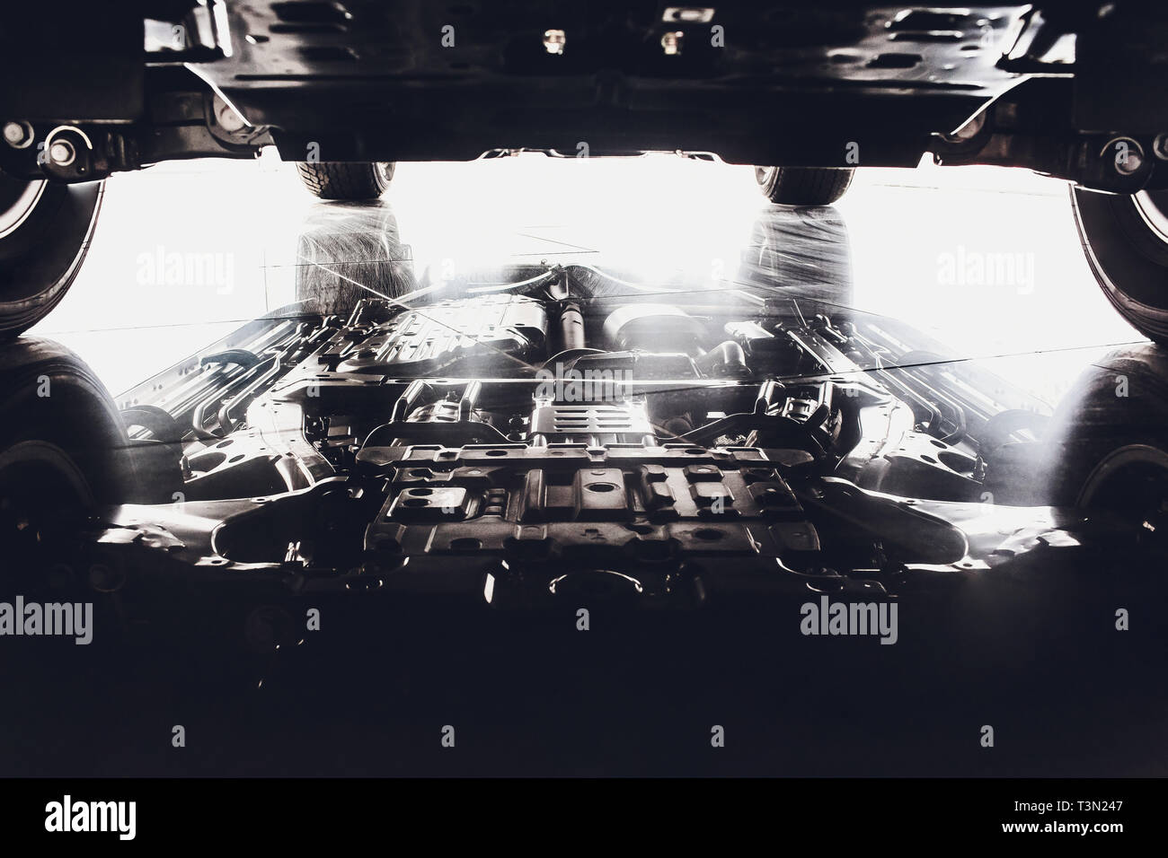 inverted car on a black background. bottom view of car Stock Photo - Alamy
