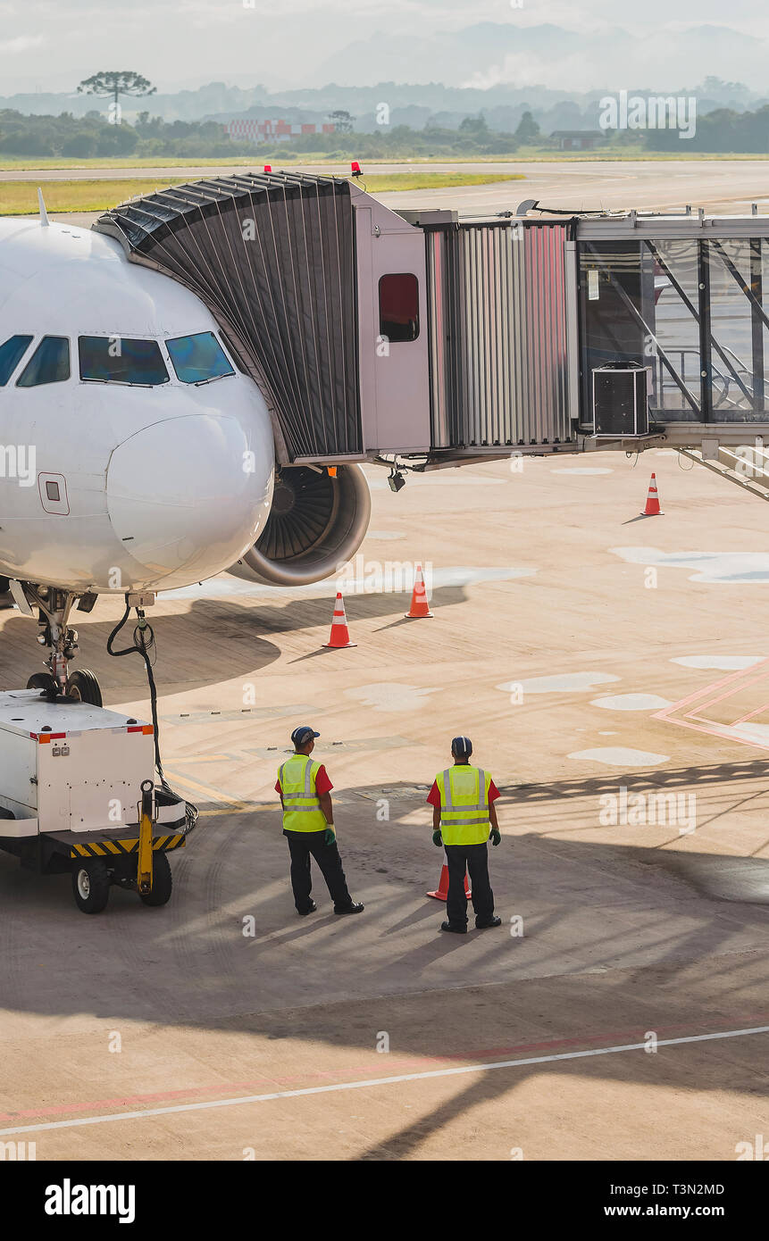 Jetway connected to the airplane for boarding passengers. Boarding ...