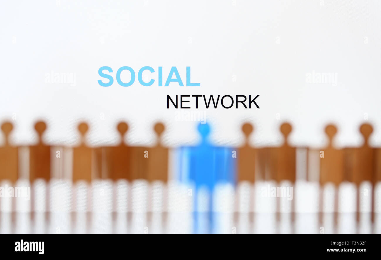 Social network sign above line of toy human figures Stock Photo - Alamy
