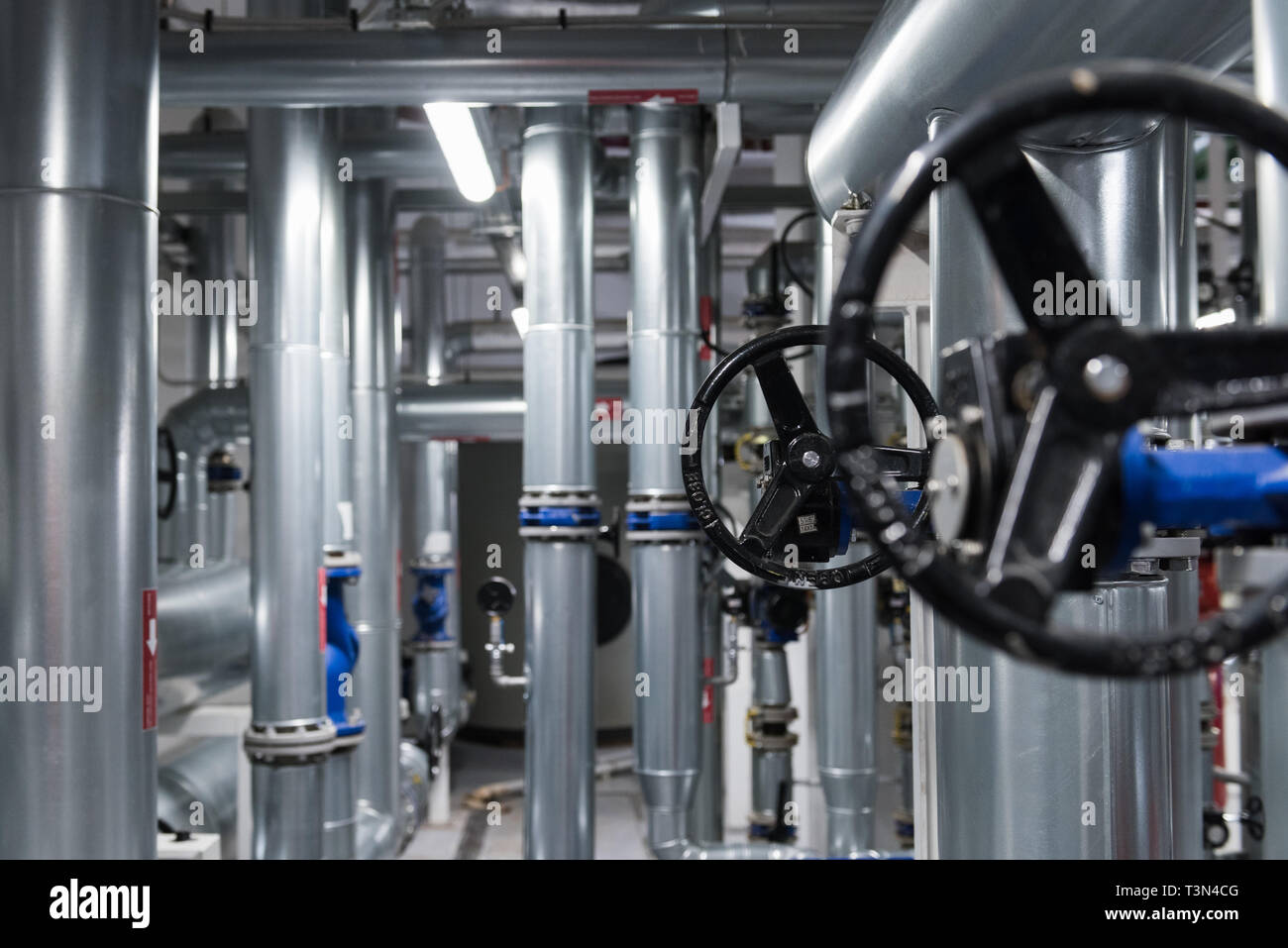 Abstract engineering background with black valve and metal pipes Stock ...