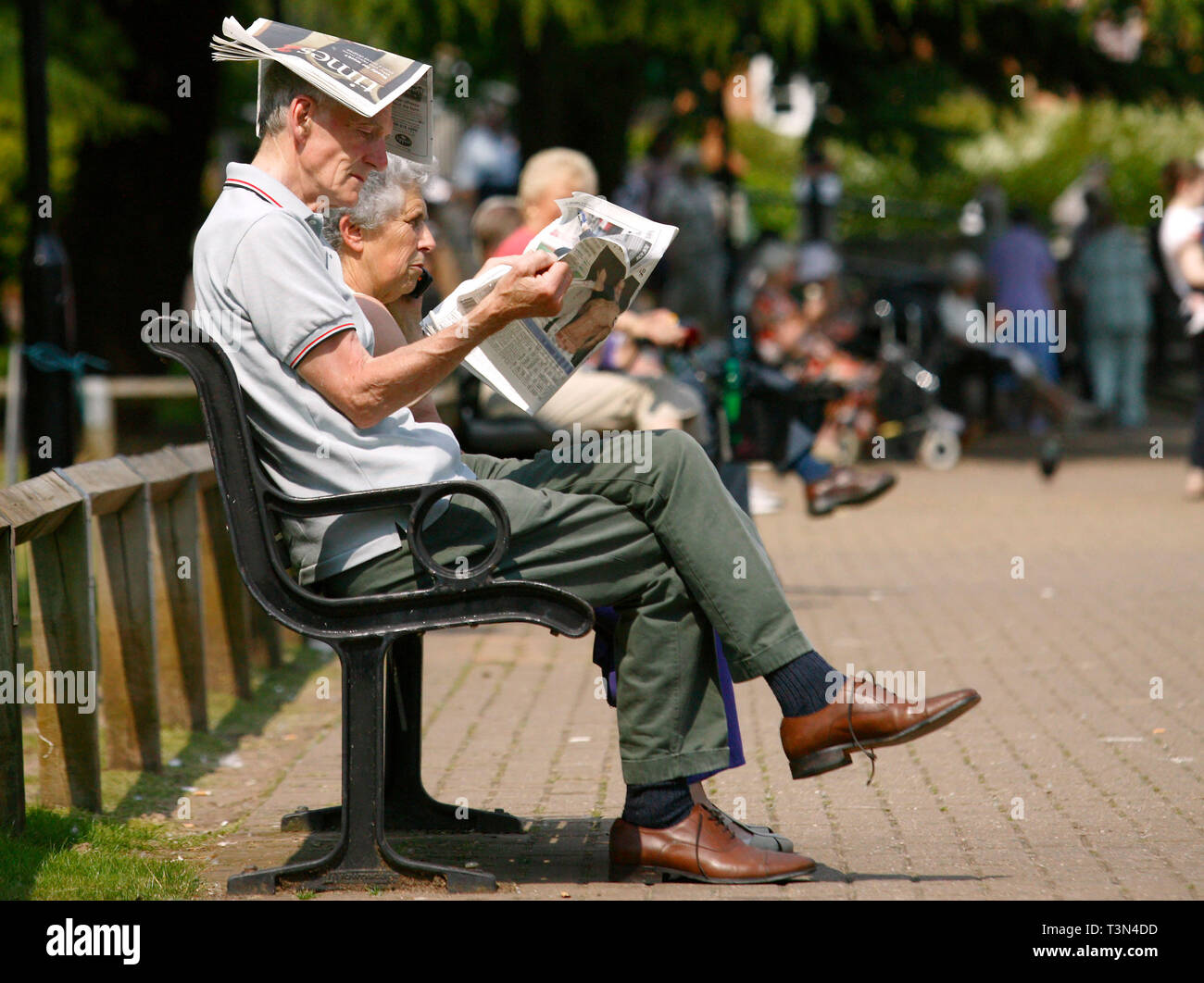An older gentleman finds a interesting way to shade himself from the ...
