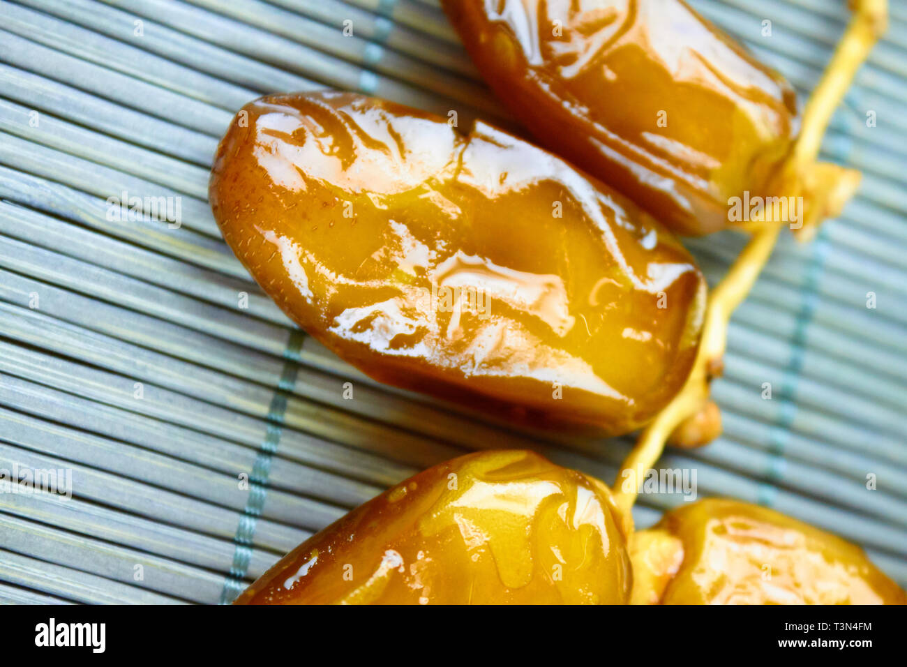 Sweet arabic algerian dates fruits on a wooden floor Stock Photo - Alamy