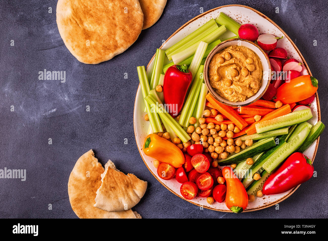 Hummus with various fresh raw vegetables, top view Stock Photo - Alamy