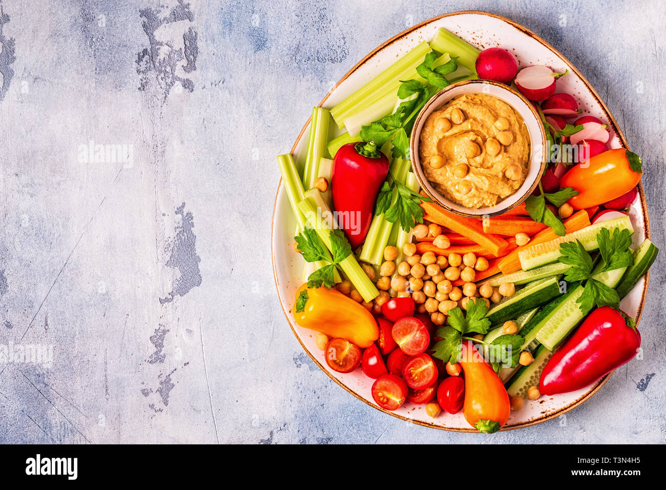 Hummus with various fresh raw vegetables, top view Stock Photo - Alamy