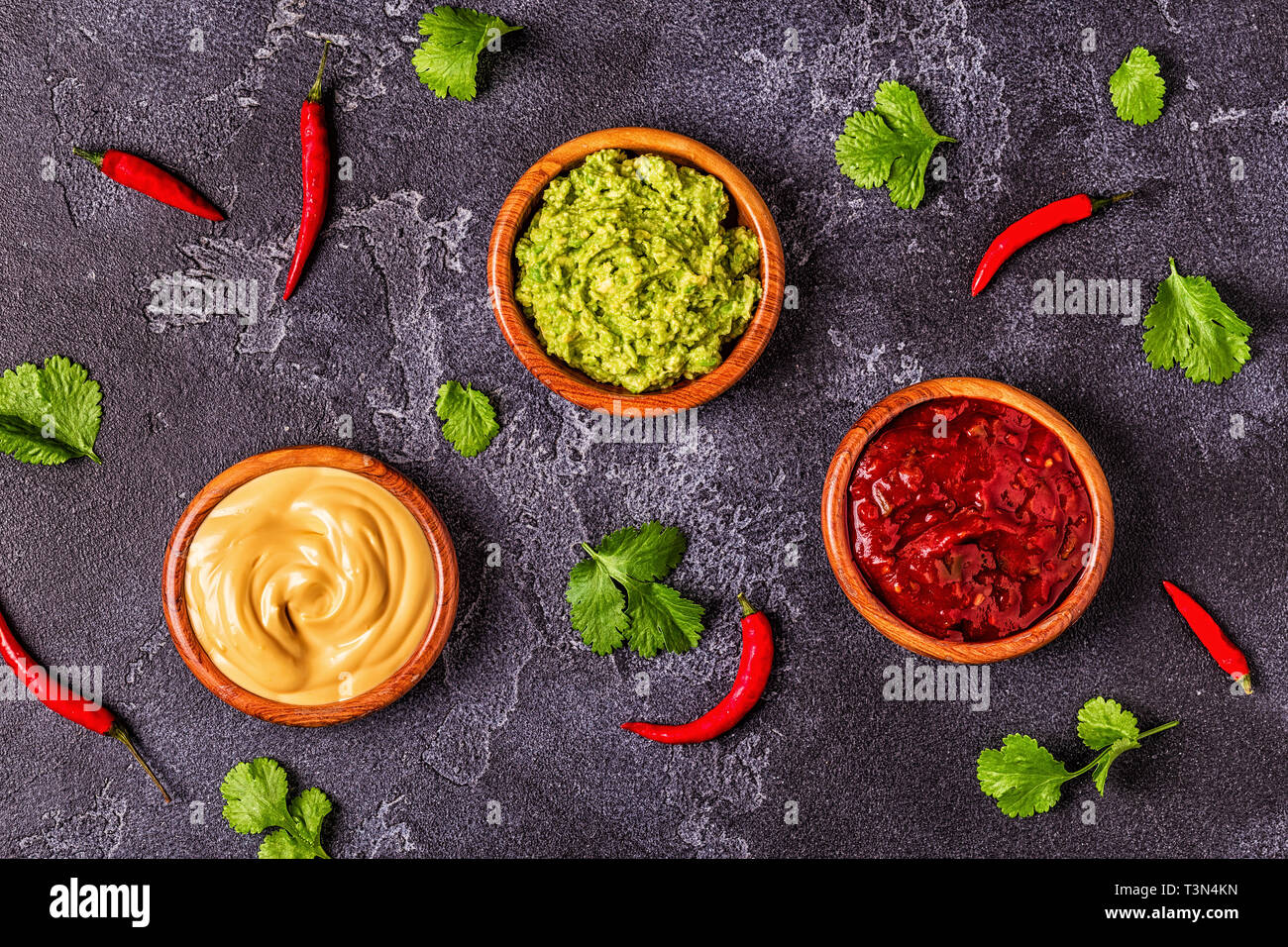 Mexican food background: guacamole, salsa, cheesy sauces with ...