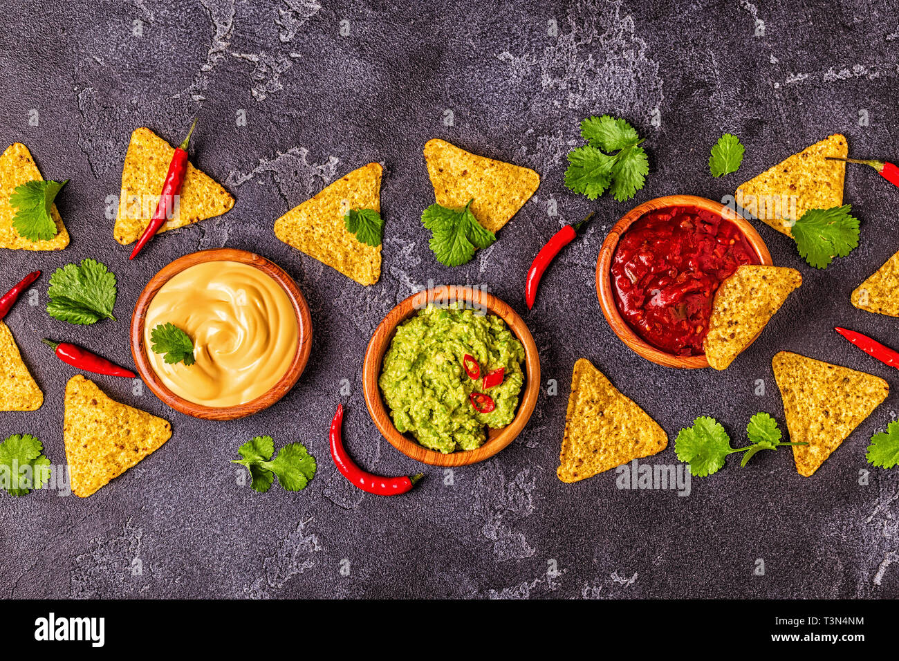 Mexican food background: guacamole, salsa, cheesy sauces with ...