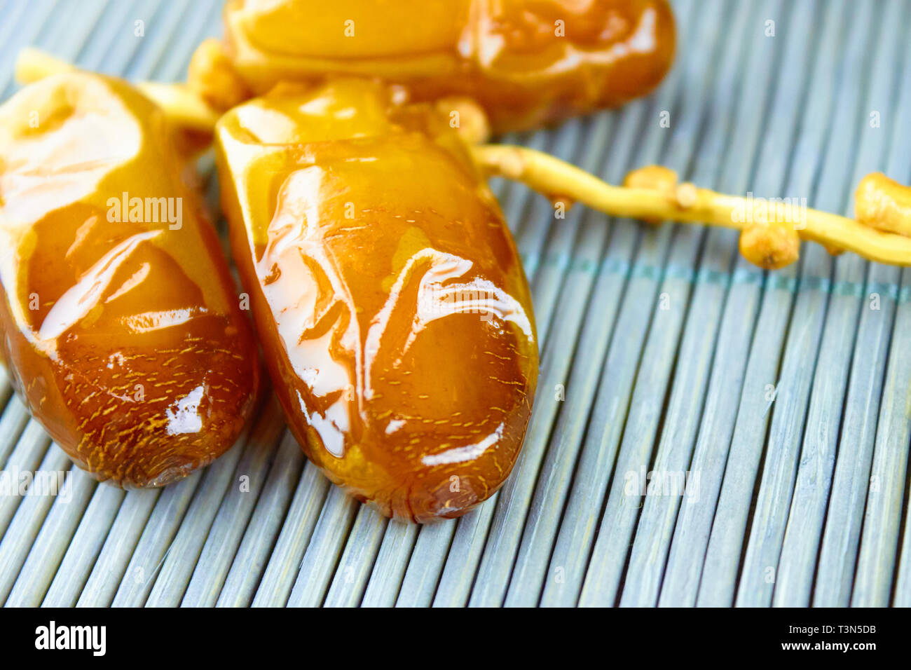 Sweet arabic algerian dates fruits on a wooden floor Stock Photo - Alamy