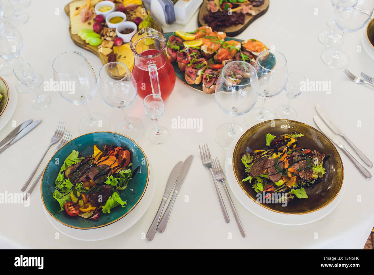 Elegant banquet table prepared for conference or party and decorated flowers for guests Stock ...