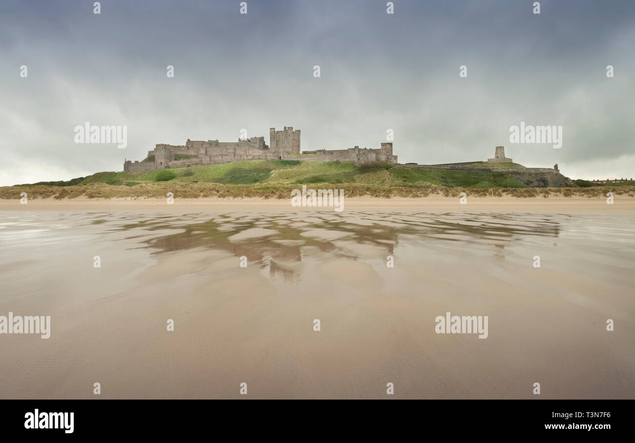 Bamburgh castle, brooding sky and beautiful empty beach, Northumberland ...