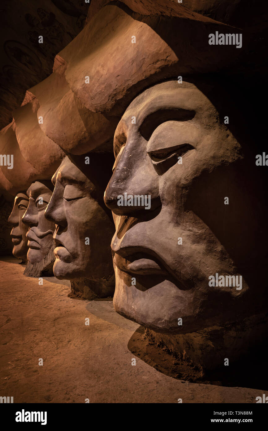 Stone heads carrying a reclining Buddha, Thousand Buddha Mountain ...