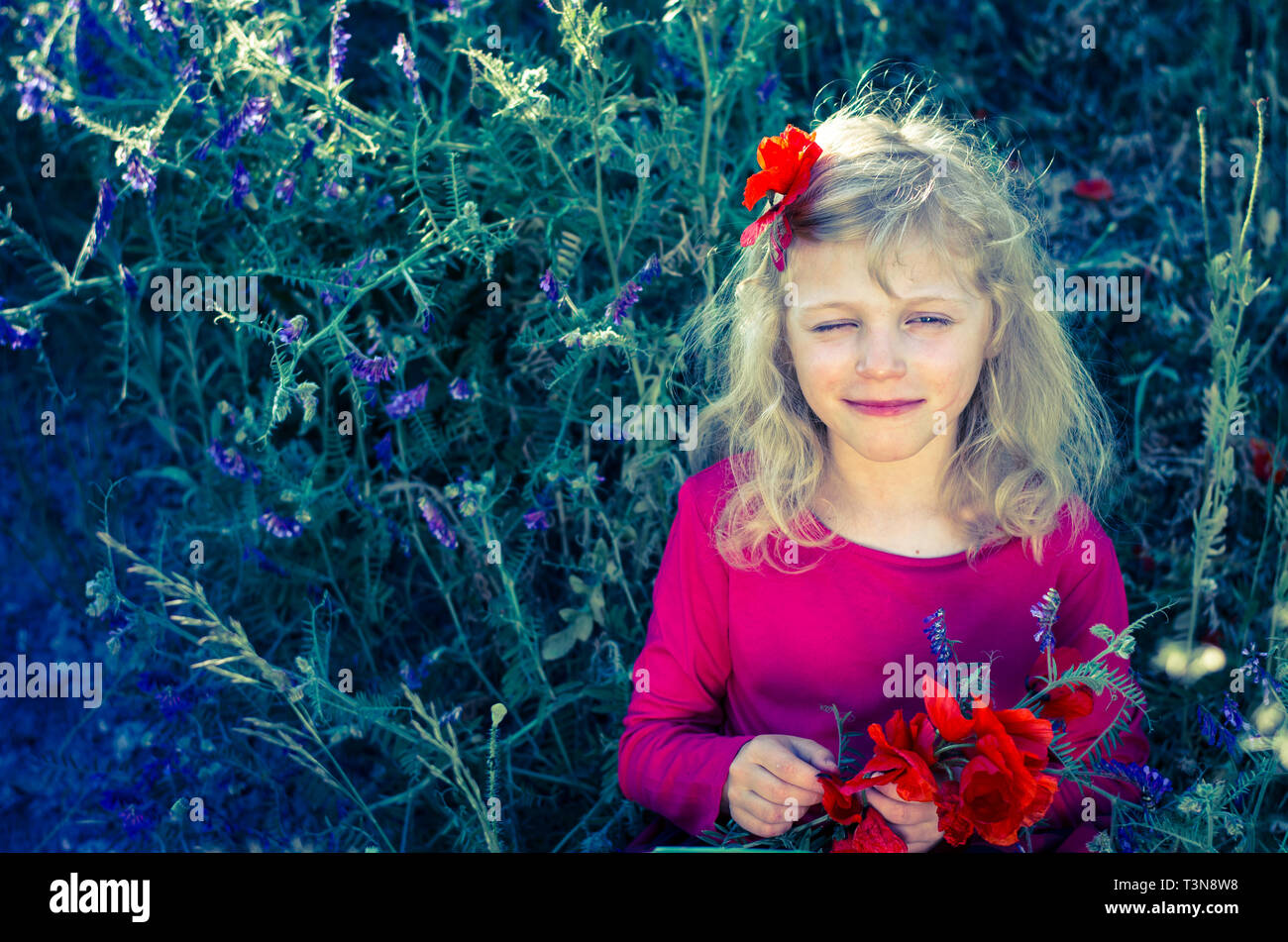 beautiful blond girl with red corn poppy flower Stock Photo - Alamy