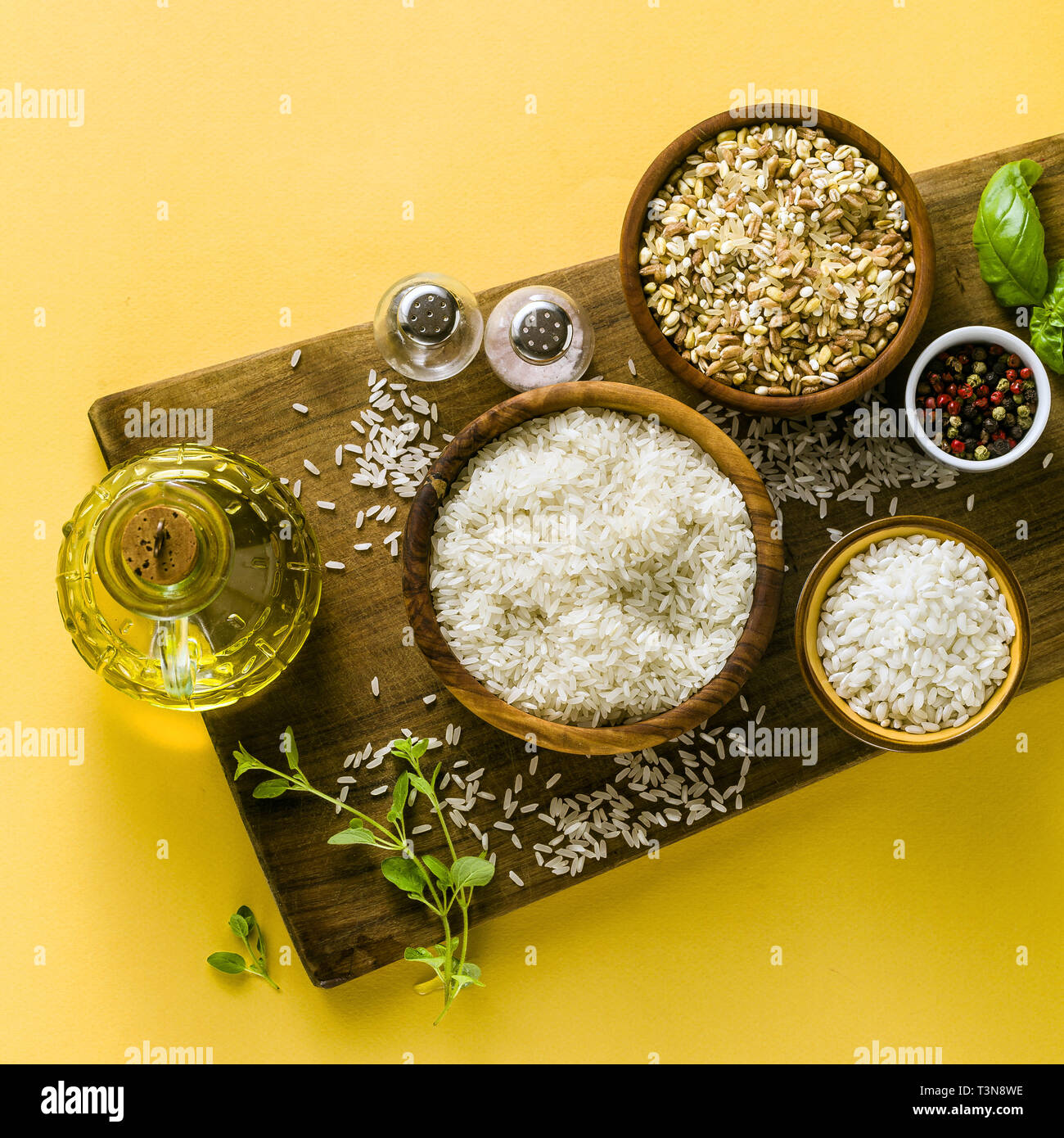 Different types of rice on a wooden board made from olive wood. Food ...