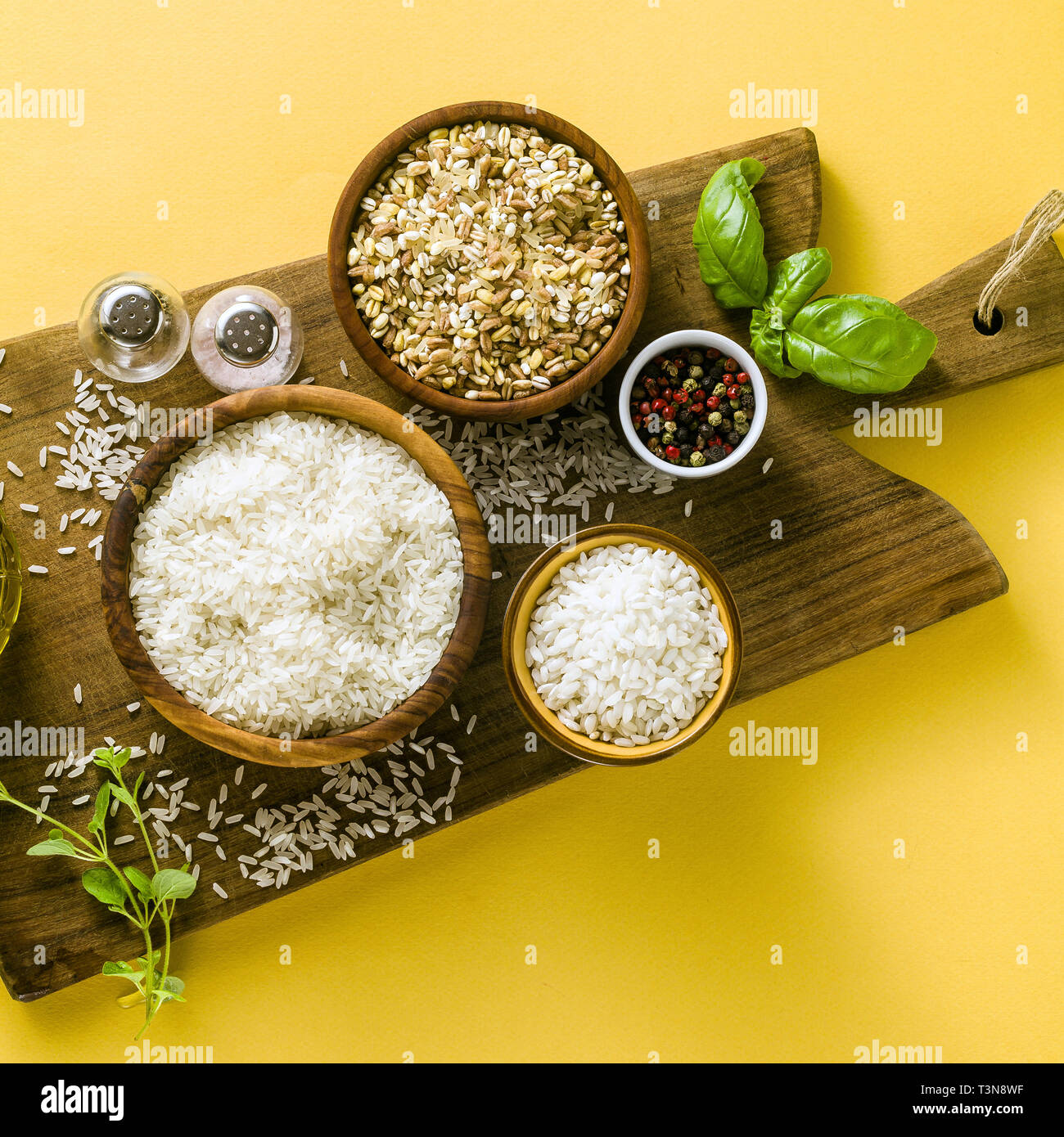 Different types of rice on a wooden board made from olive wood. Food ...