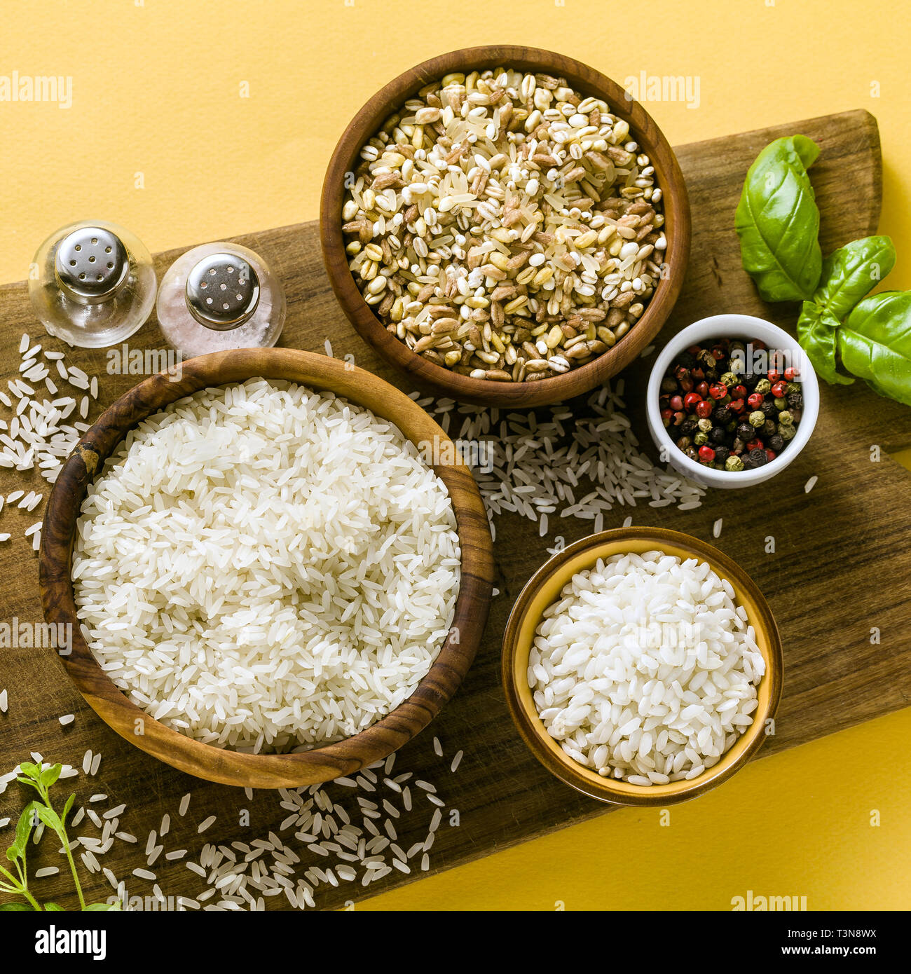 Different types of rice on a wooden board made from olive wood. Food ...