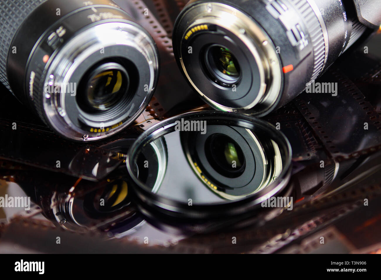 Close up of two camera lenses with isolated circular filter on negative ...
