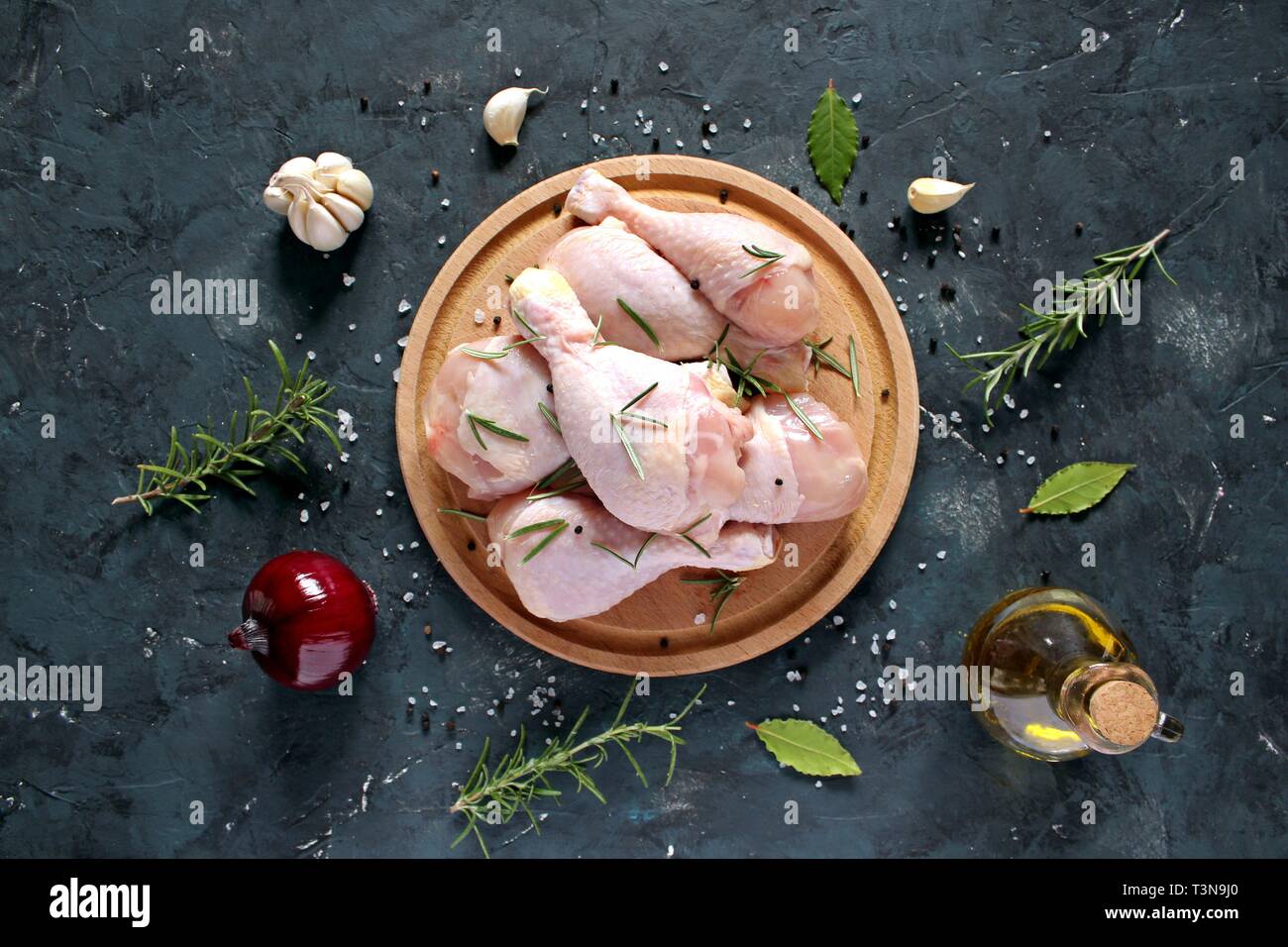 Raw uncooked chicken legs with ingredients for cooking, drumsticks on ...