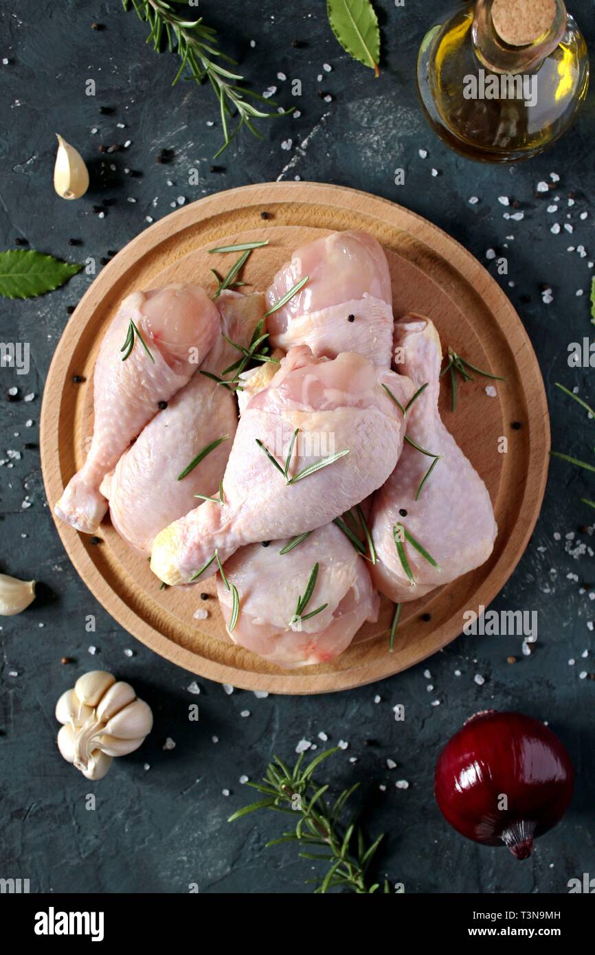 Raw uncooked chicken legs with ingredients for cooking, drumsticks on ...