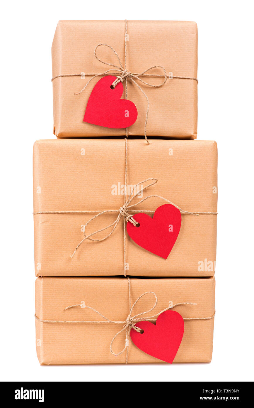 Stacked gift boxes with blank heart-shaped labels isolated on white ...