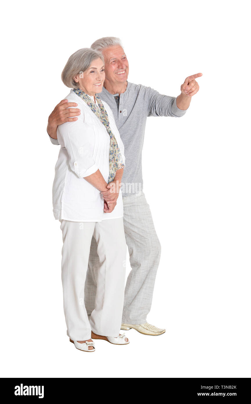Full length portrait of senior couple pointing something isolated on ...
