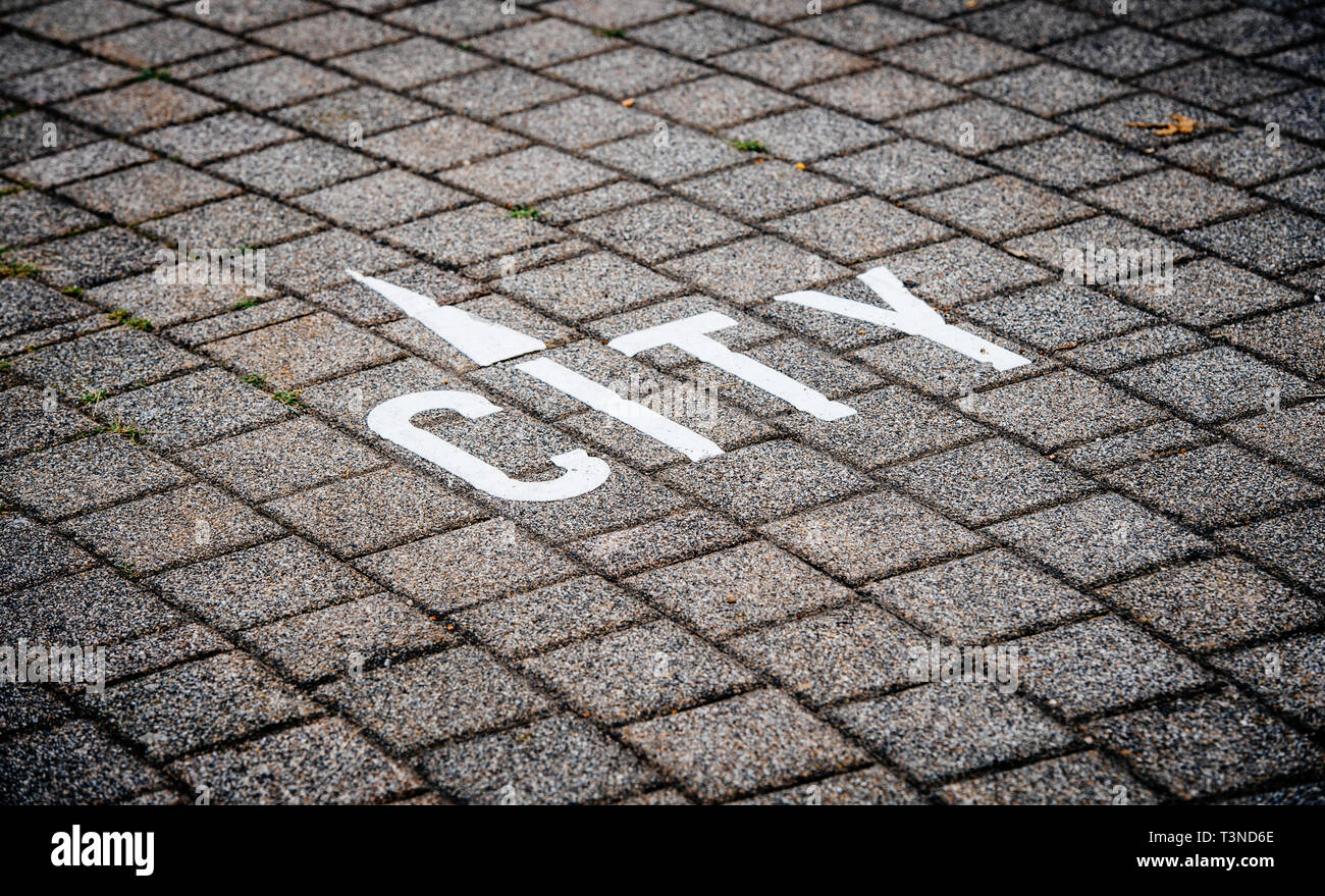 City sign with white arrow from letter I painted on the cobblestone in ...