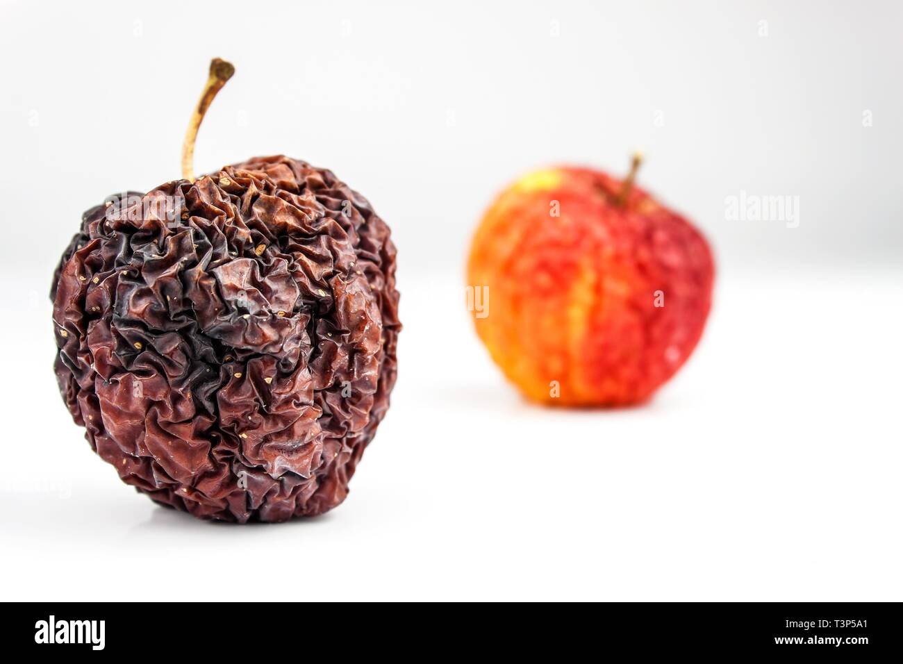 Wrinkled apple texture with white background. Shriveled apple. Old ...