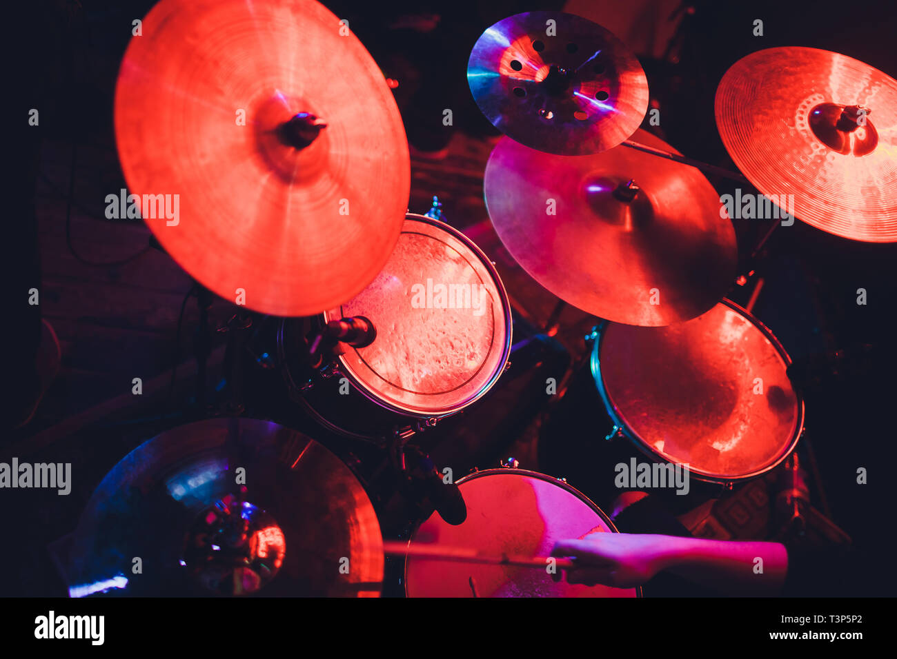 Drummer playing drum set at concert on stage. Music show. Bright scene ...