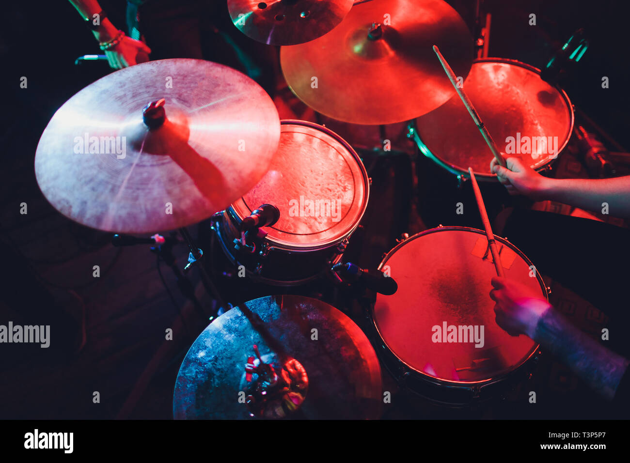 Drummer playing drum set at concert on stage. Music show. Bright scene ...