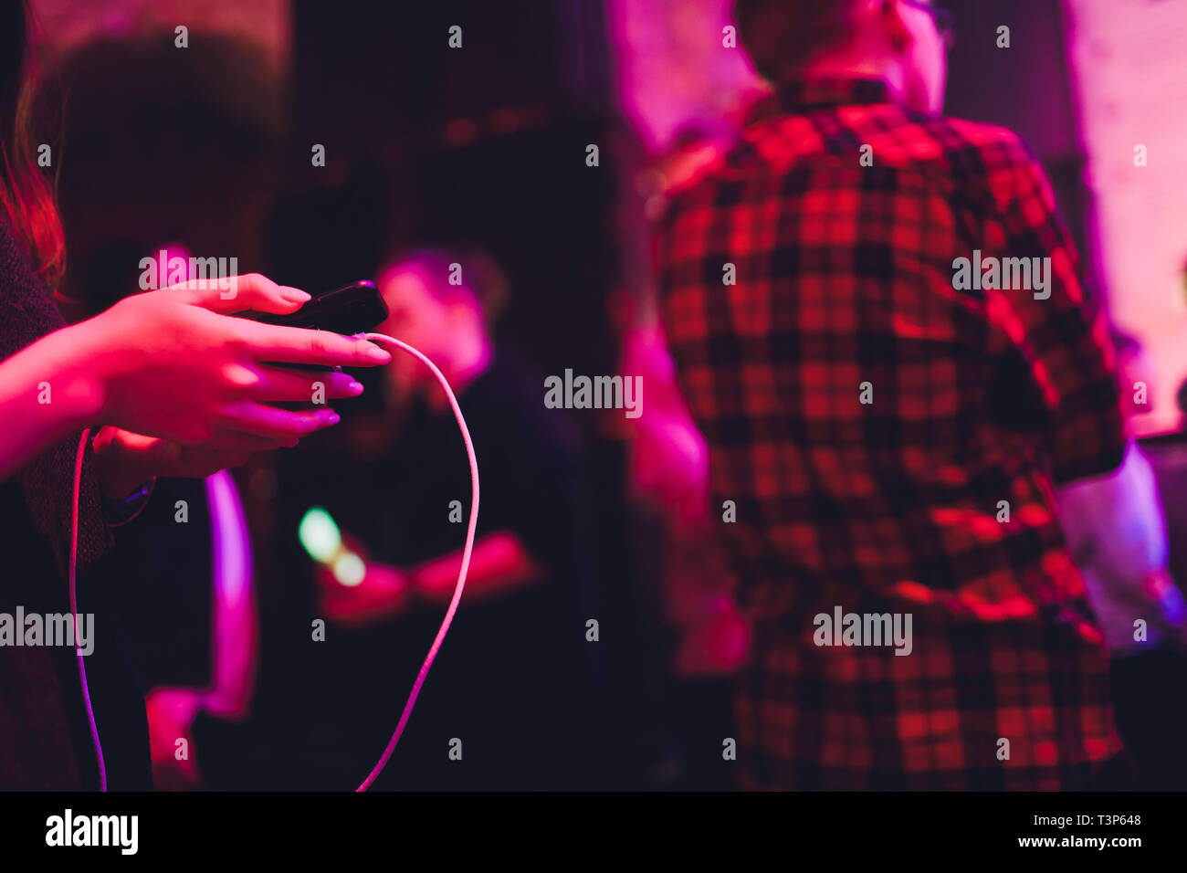 Girl using smart phone while charging on the power bank Stock Photo - Alamy