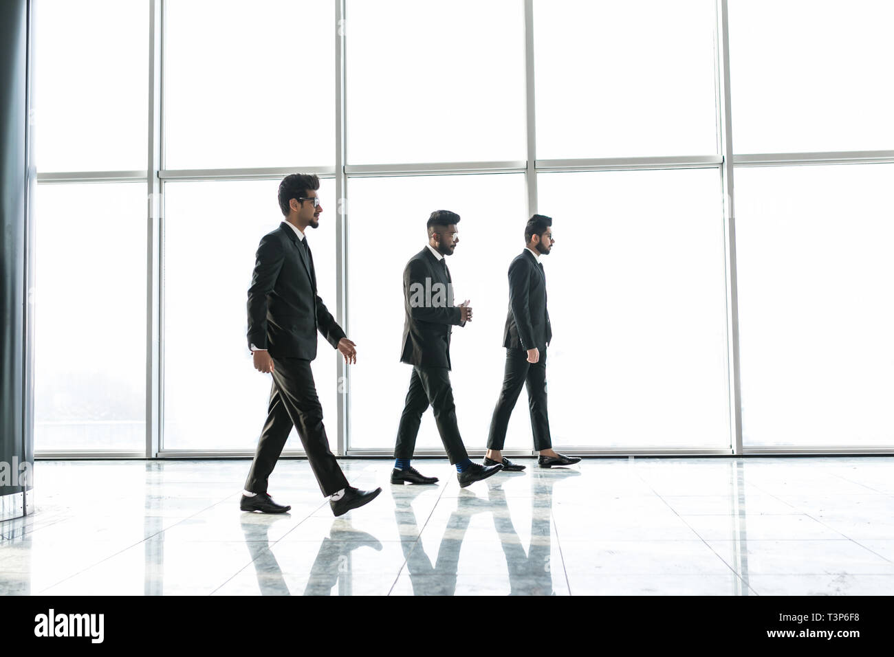 Business people walking in the office corridor Stock Photo - Alamy