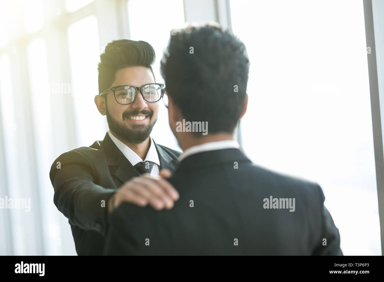 Happy handsome indian businessman shaking hands on business deal at ...