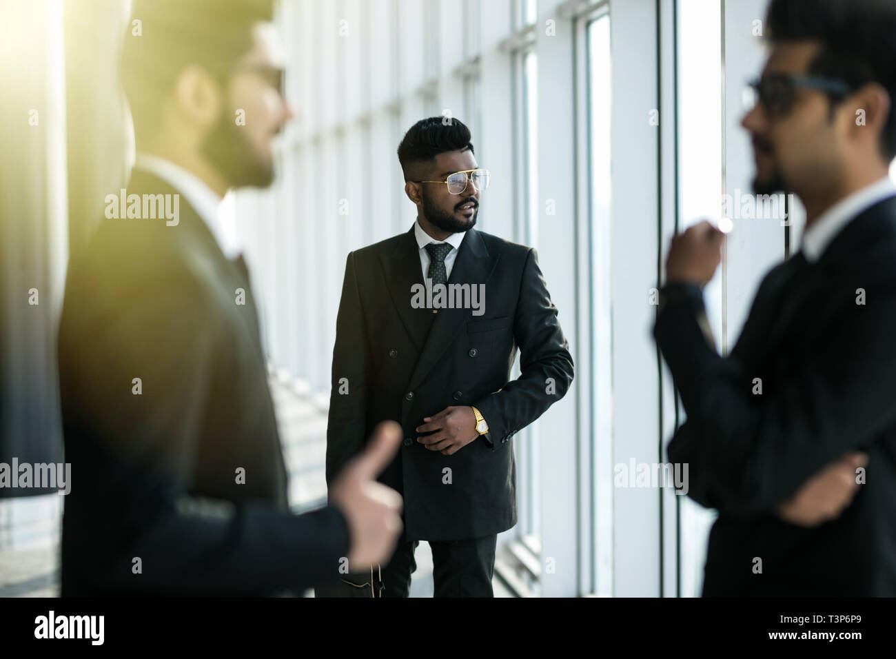 Young indian business man discuss plans in front of collegue standing ...