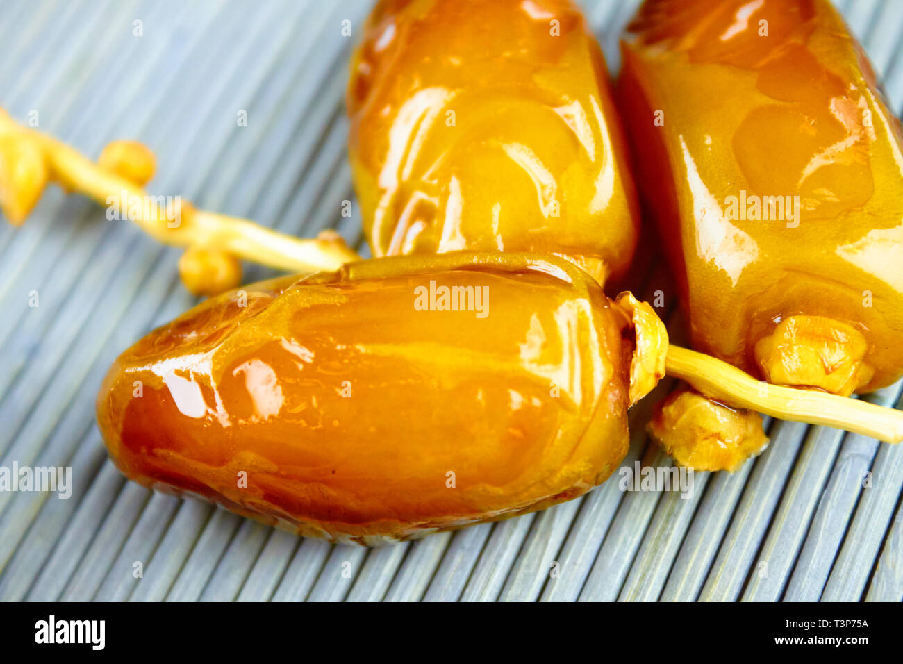 Sweet arabic algerian dates fruits on a wooden floor Stock Photo - Alamy