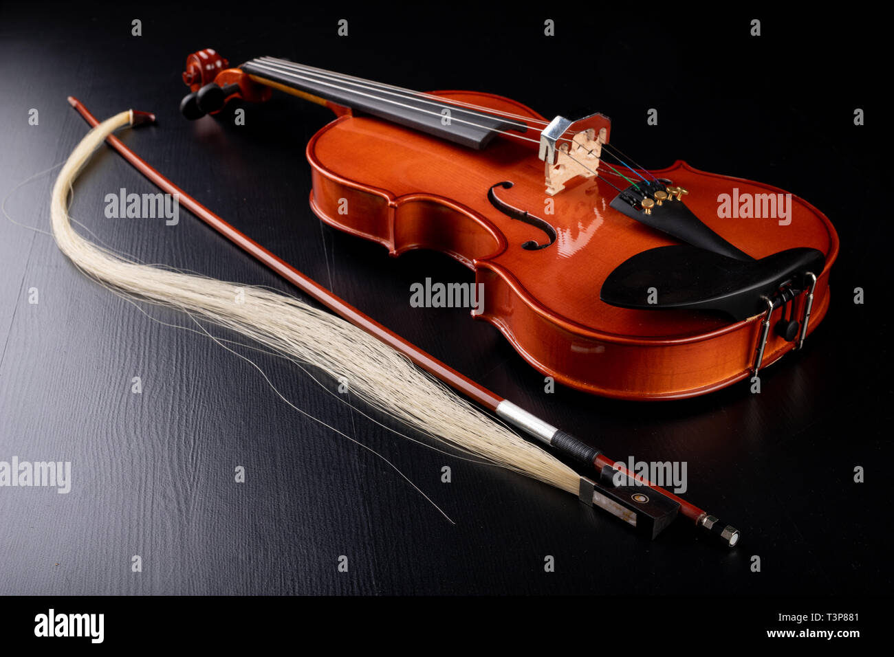 Broken bow to the violin. Damaged musical instrument. Dark background ...