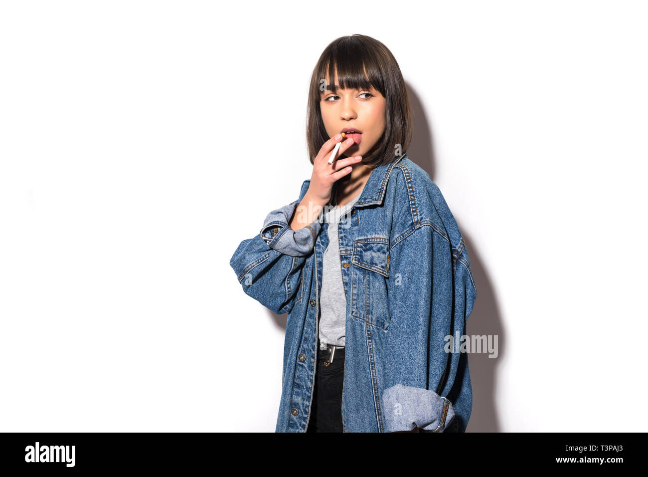 Stylish authentic hipster woman smoking rolled cigarette. Full body ...