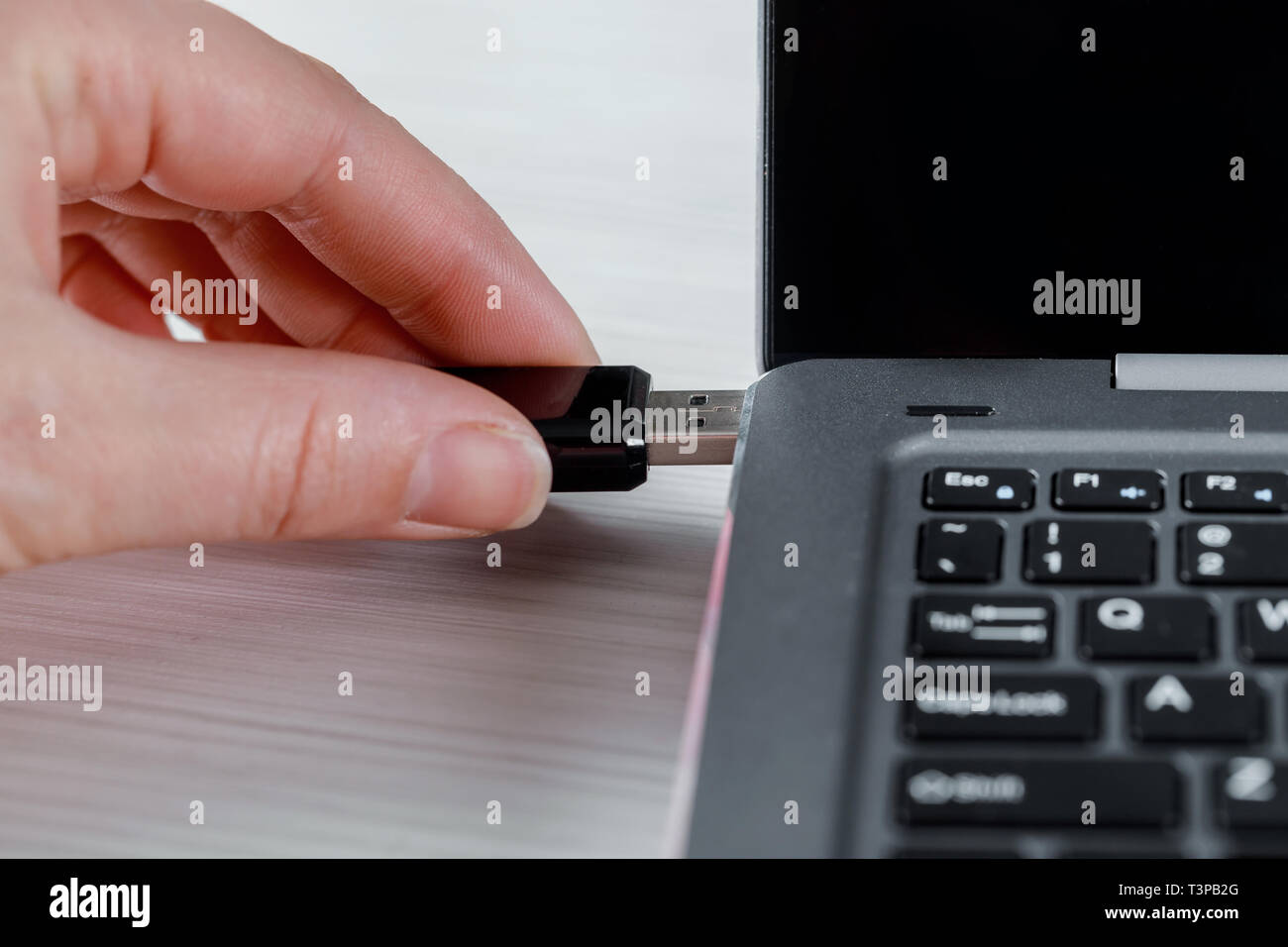 Female hand inserting USB flash drive and laptop Stock Photo - Alamy