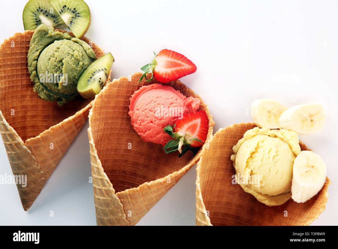 Set of ice cream scoops of different colors and flavours with berries ...