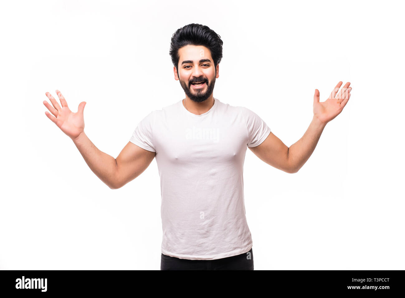 Standing handsome man wondering, raising his two hands isolated on a ...