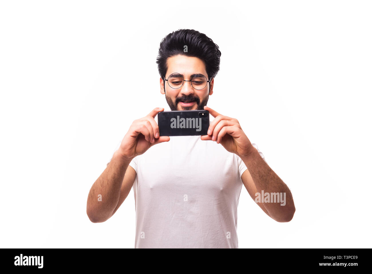 young smiling casual man taking a picture of you with his phone ... young smiling casual man taking a picture of you with his phone ...